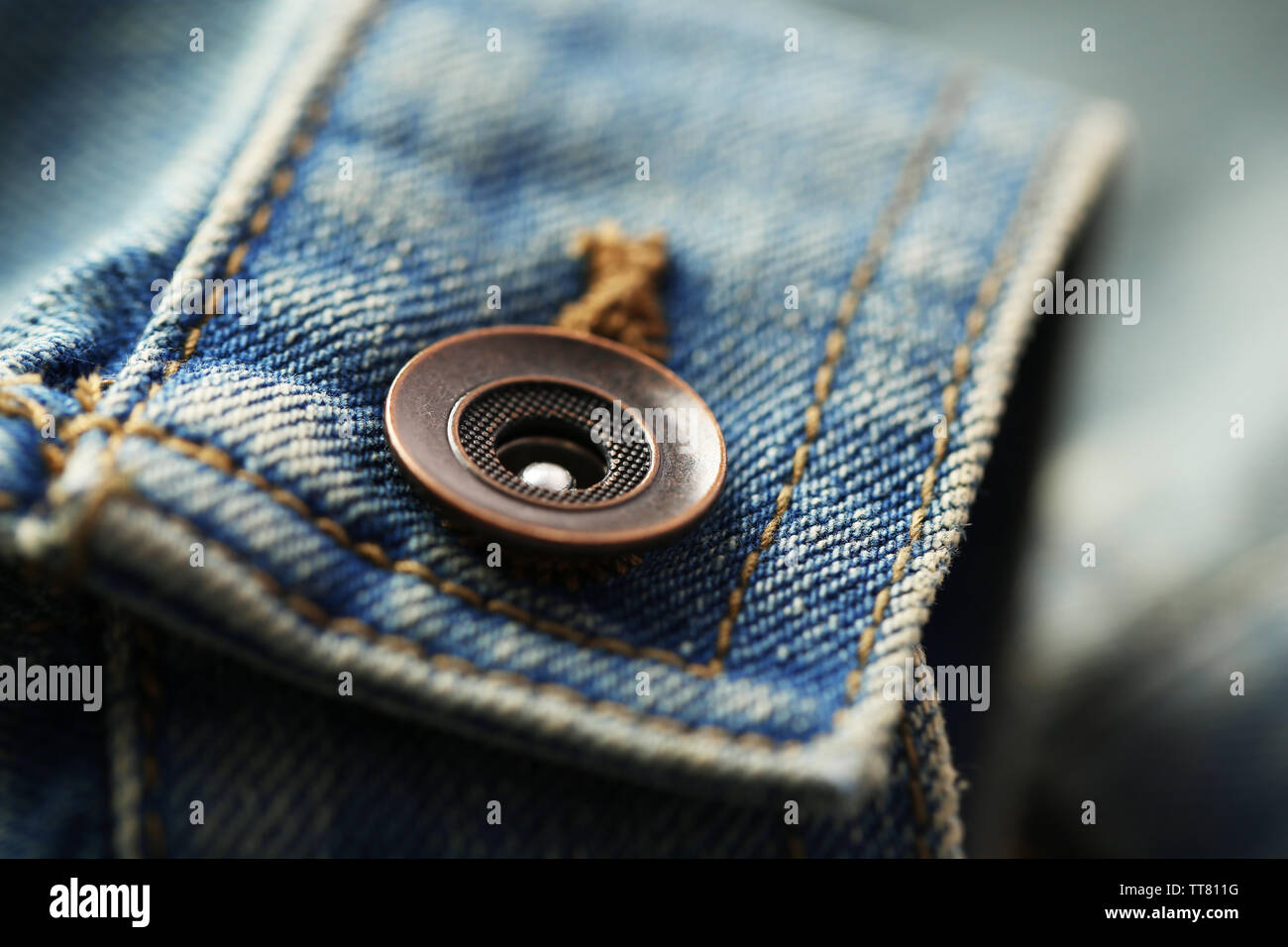 Metal button on clothes close up Stock Photo - Alamy