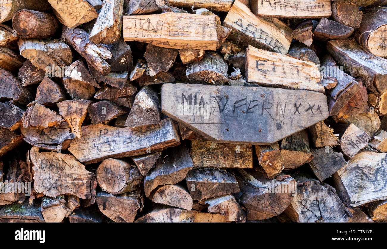 Log stack with names written on Stock Photo - Alamy
