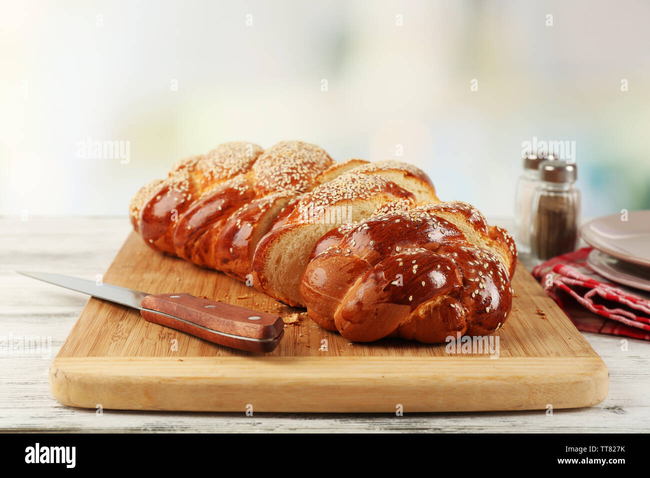 Sliced fresh bun on cutting board on bright background Stock Photo - Alamy