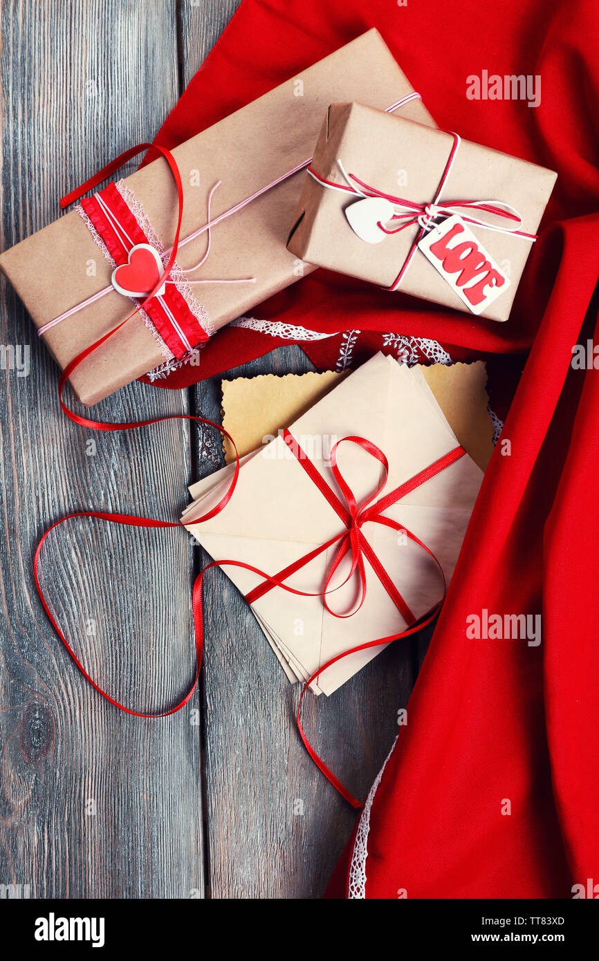 Love letters with gifts on wooden background Stock Photo - Alamy