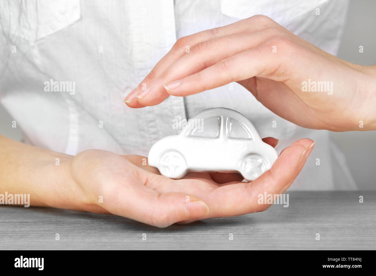 Hands and toy car. Protection of car concept Stock Photo - Alamy