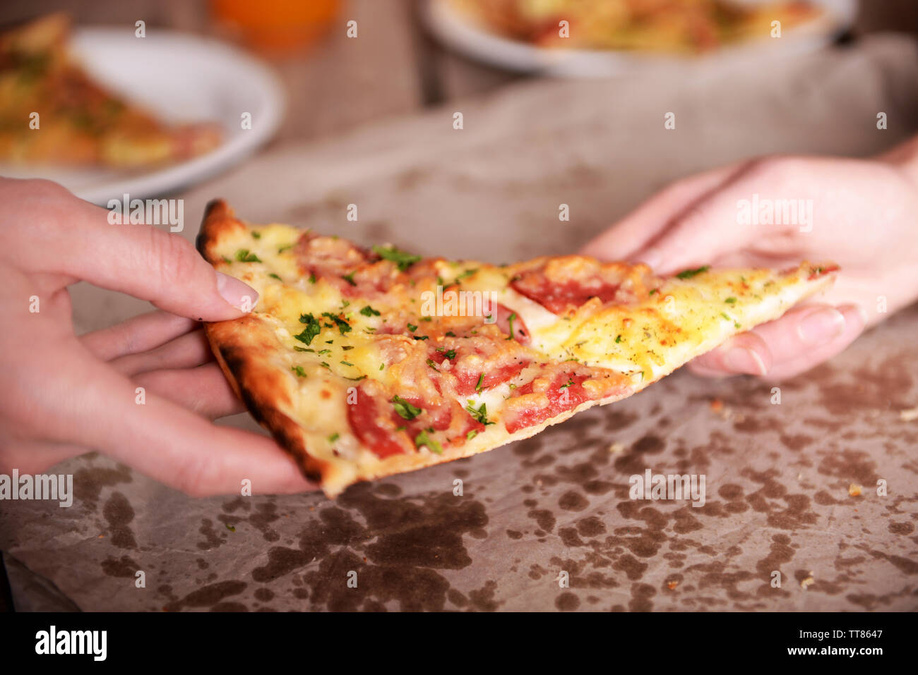 Friends hands taking slice of pizza Stock Photo - Alamy