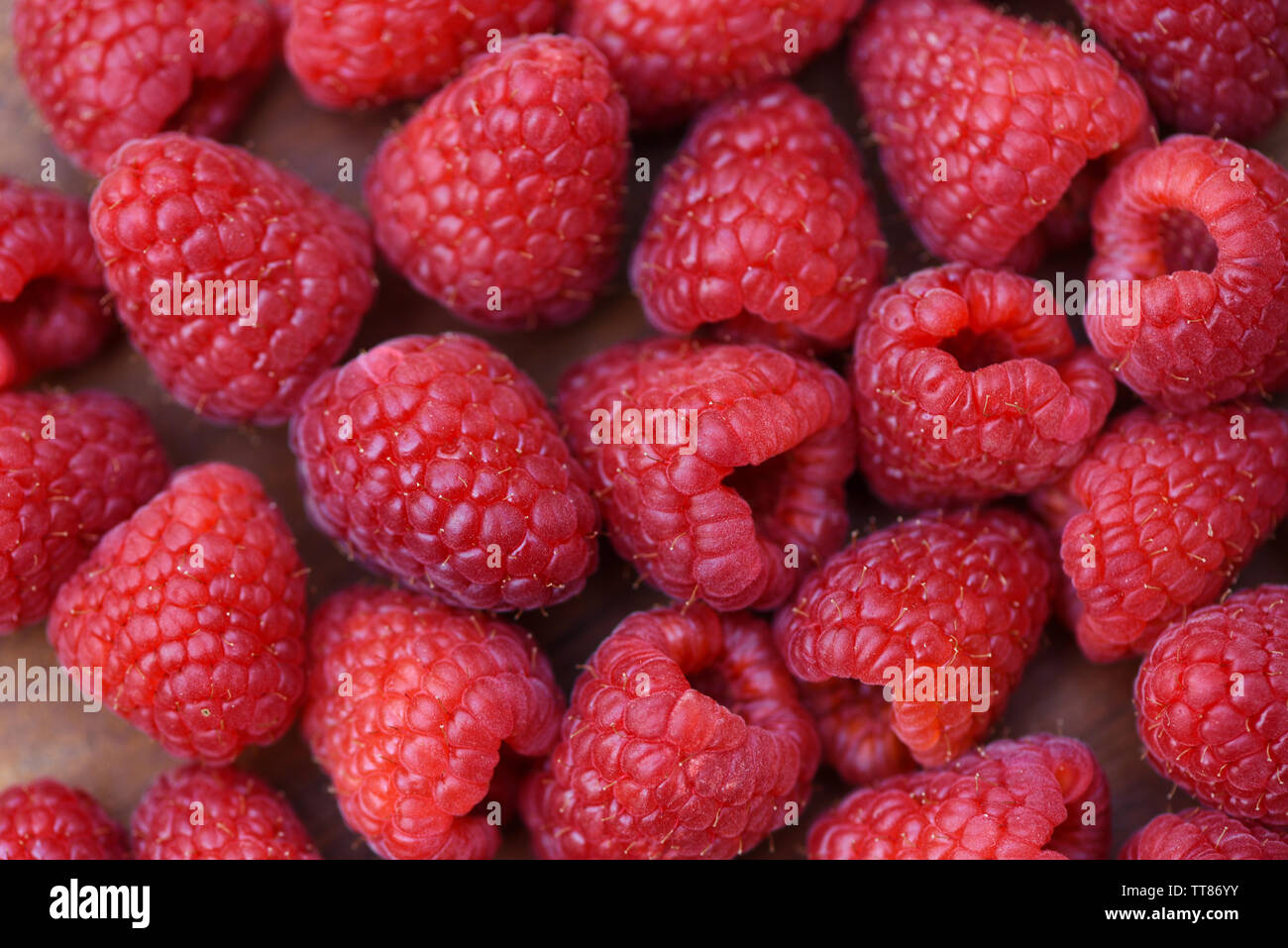Fresh raspberry texture / Close up red raspberries fruit background top ...