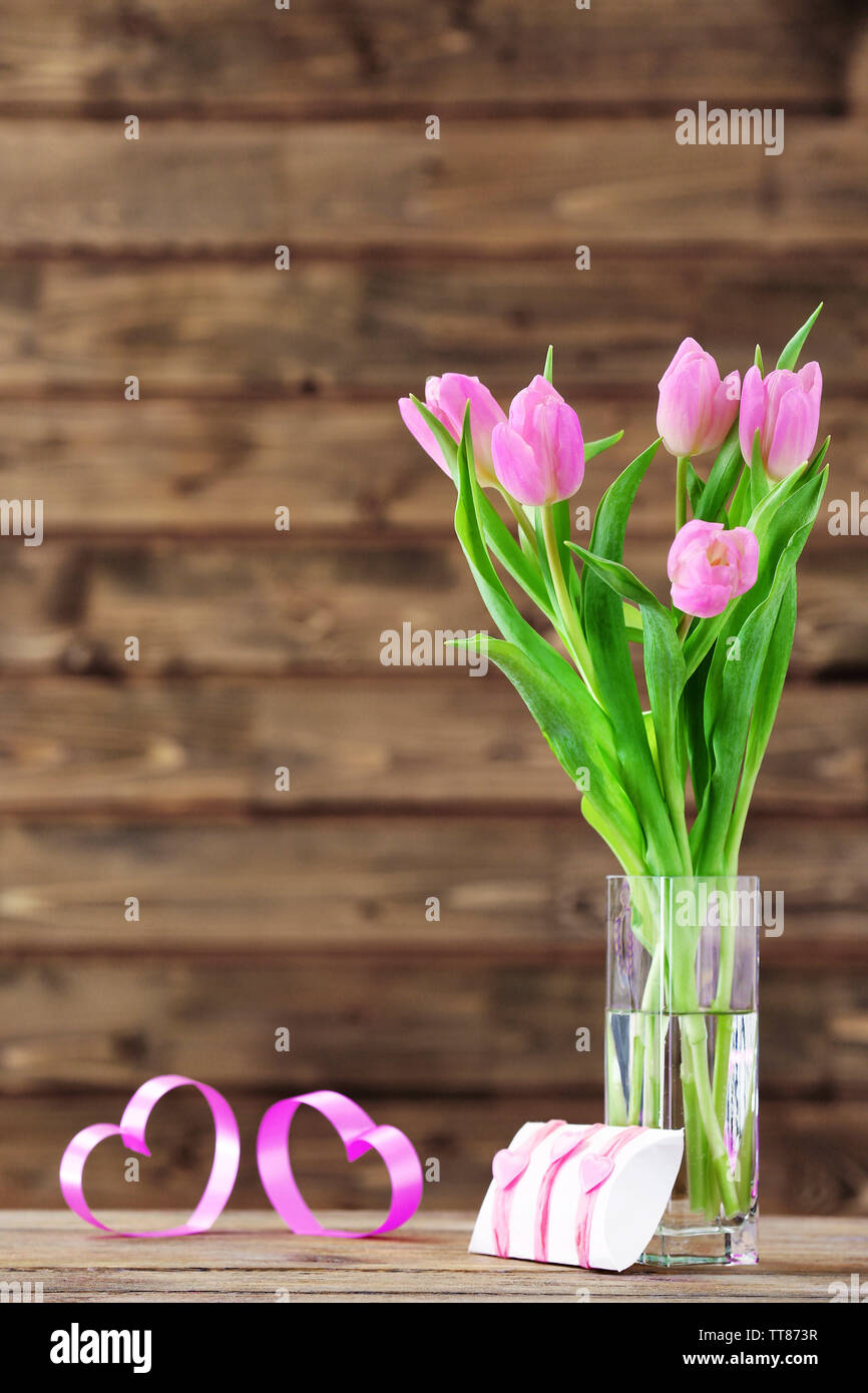 Beautiful pink tulips with present box on wooden background Stock Photo ...