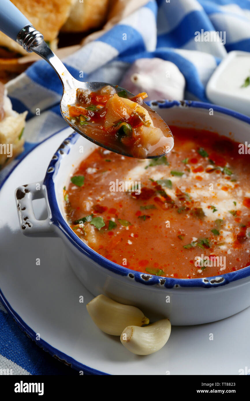 Ukrainian beetroot soup - borscht, on blue napkin, on wooden background ...