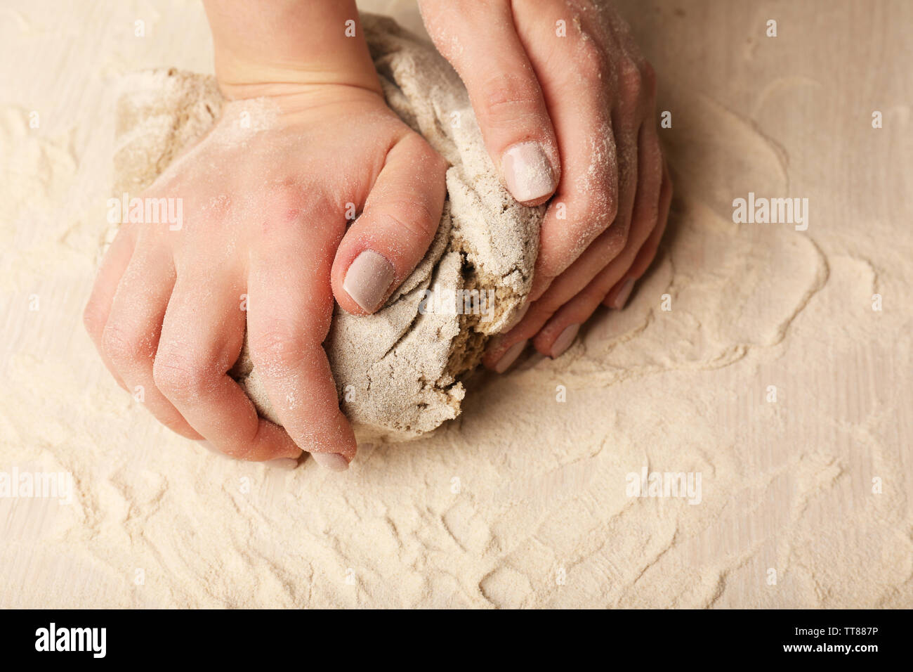 Making dough by female hands on wooden table background Stock Photo - Alamy