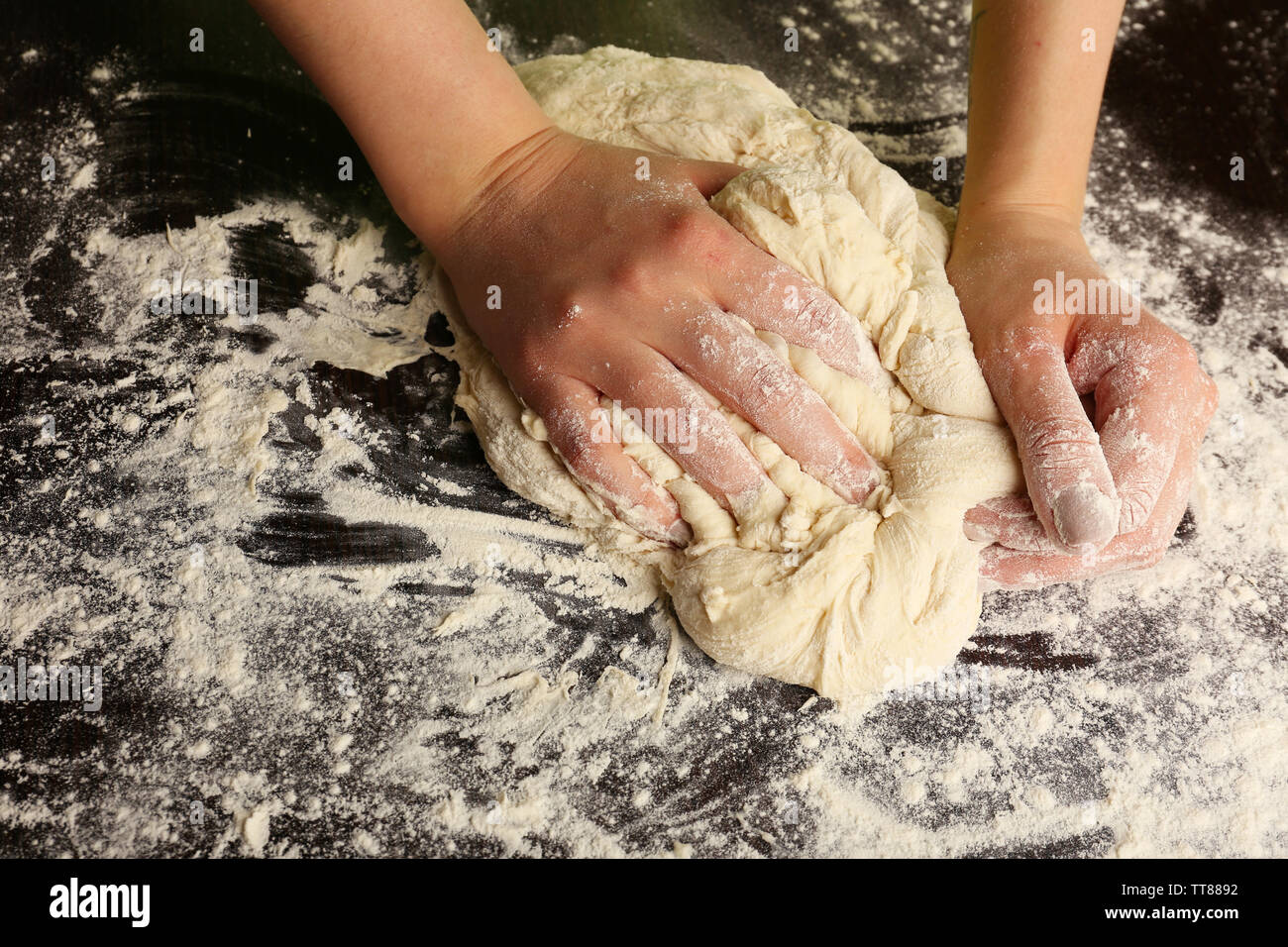 Making dough by female hands on wooden table background Stock Photo - Alamy