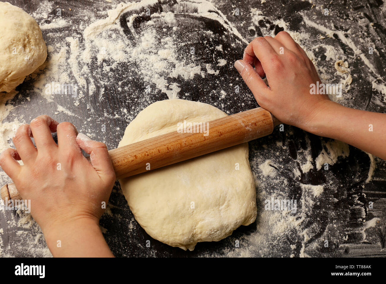 Making dough by female hands on wooden table background Stock Photo - Alamy