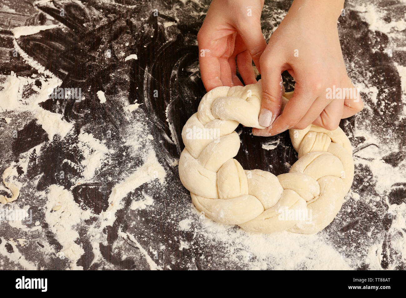 Making pie by female hands on wooden table background Stock Photo - Alamy