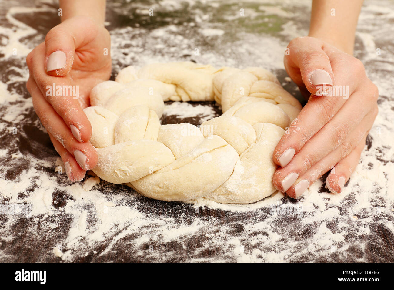 Making pie by female hands on wooden table background Stock Photo - Alamy