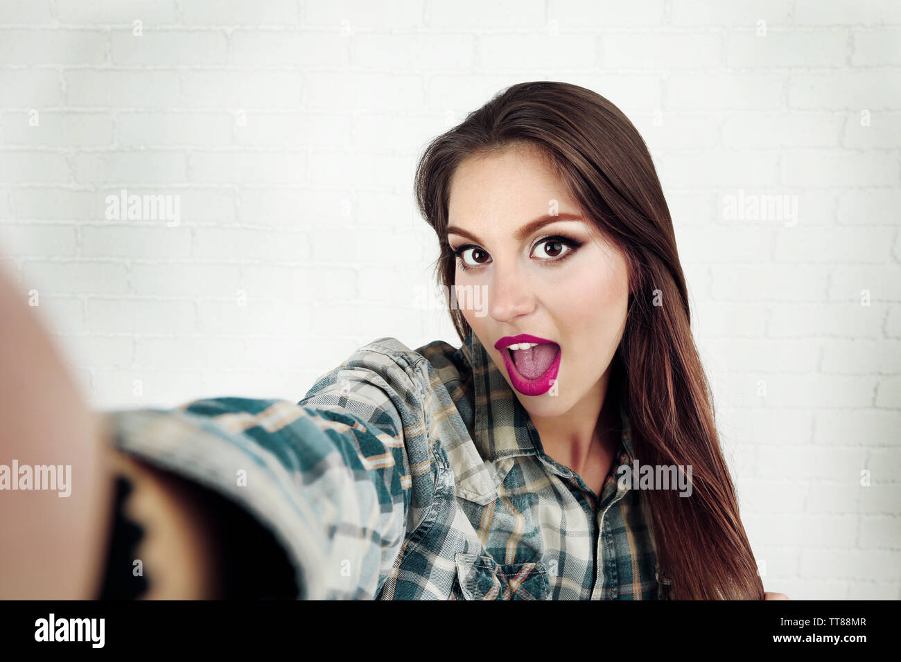 Beautiful Stylish Girl Making Selfie On Brick Wall Background Stock