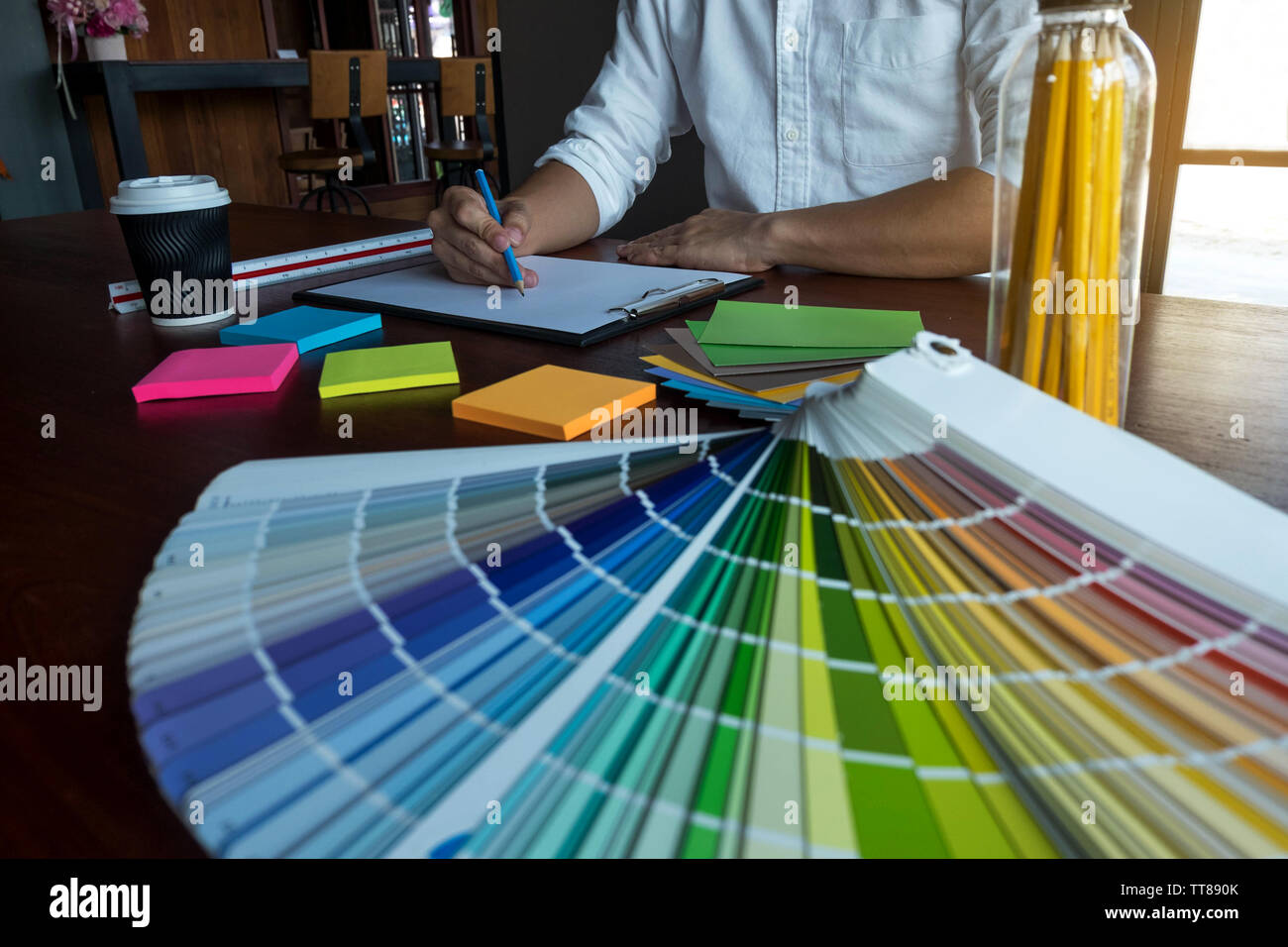 Graphic designer choose colors from the color bands samples for design ...