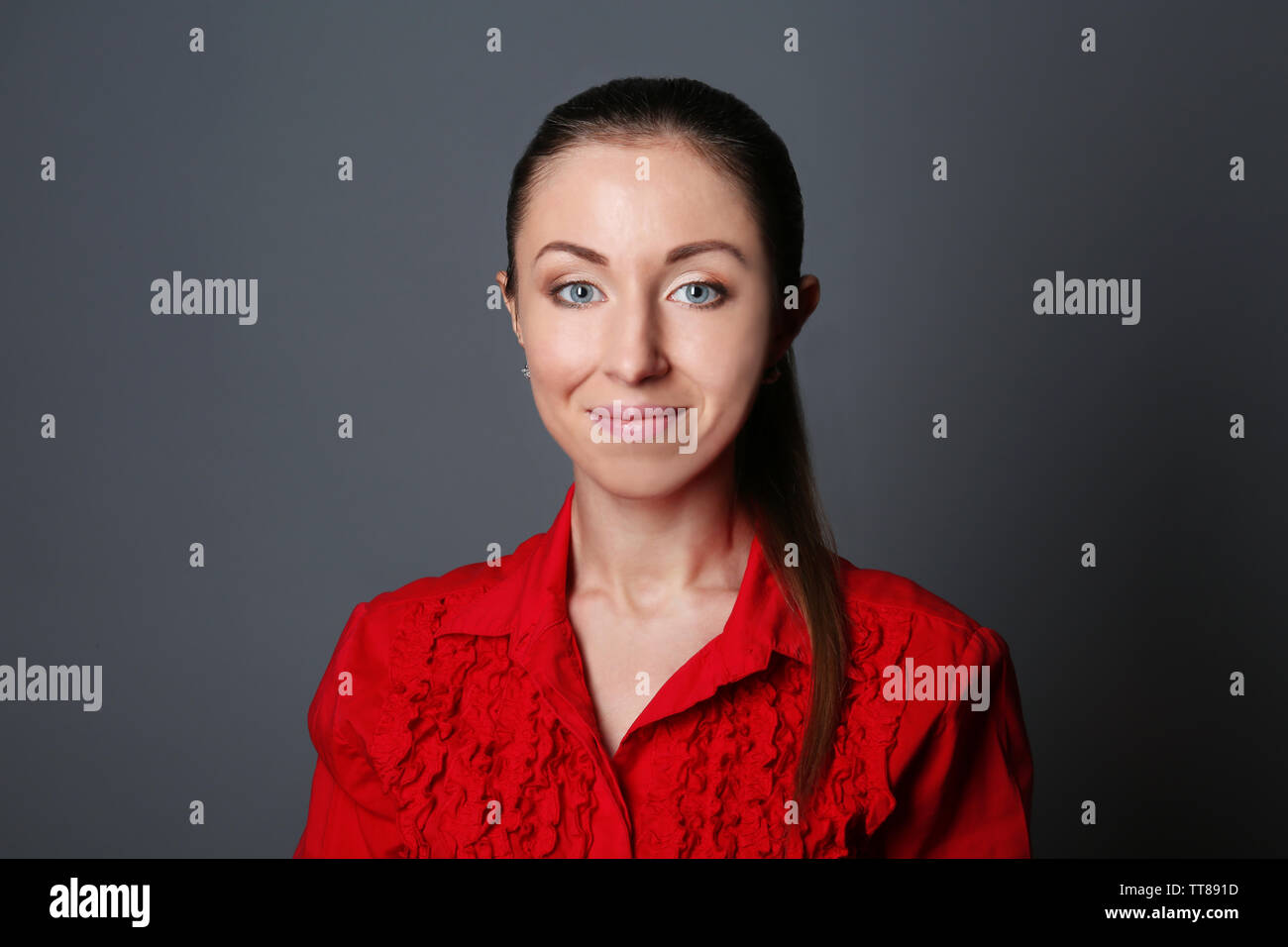 Portrait of young woman on grey background Stock Photo - Alamy