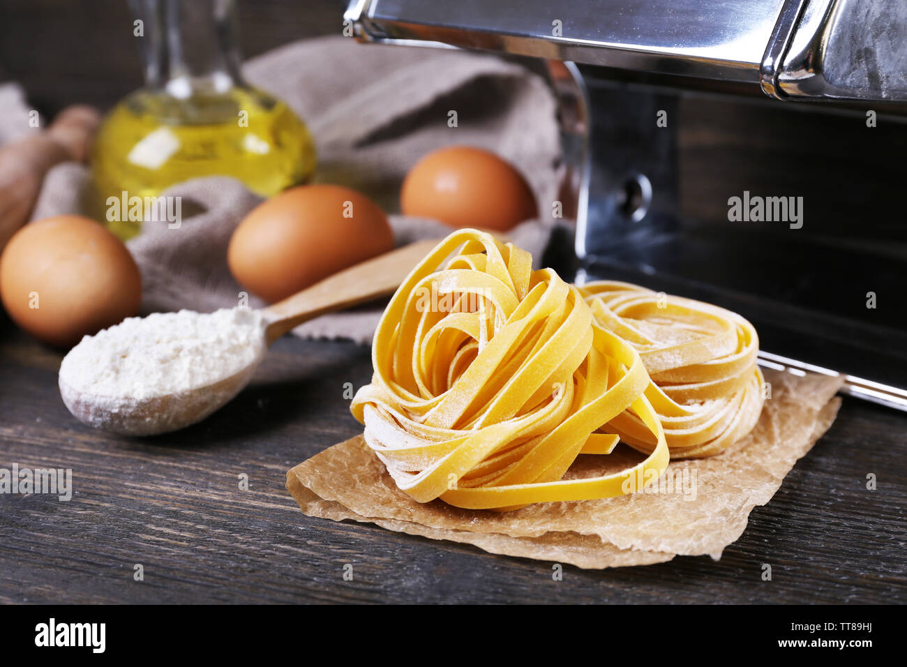 Preparing pasta by pasta machine on rustic wooden background Stock ...