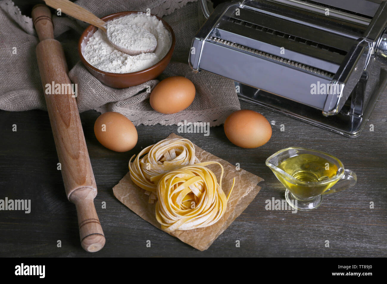 Preparing pasta by pasta machine on rustic wooden background Stock ...