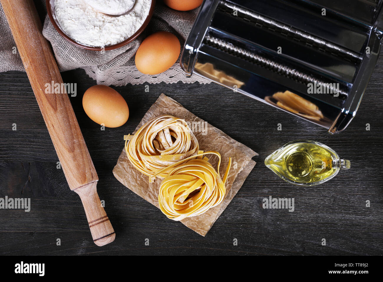 Preparing pasta by pasta machine on rustic wooden background Stock ...