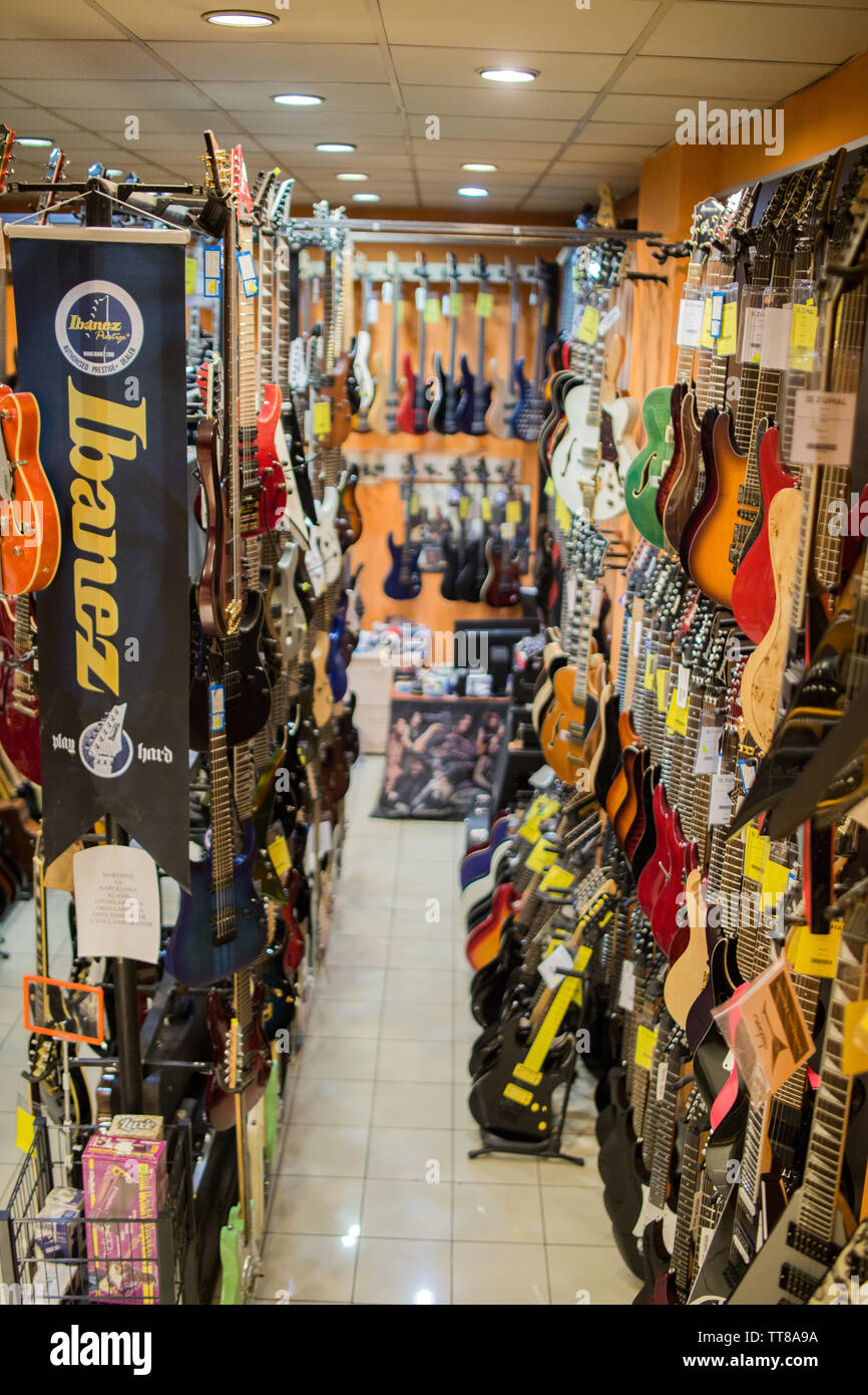 lots of electric guitars on sale at music store guitarists heaven Stock ...