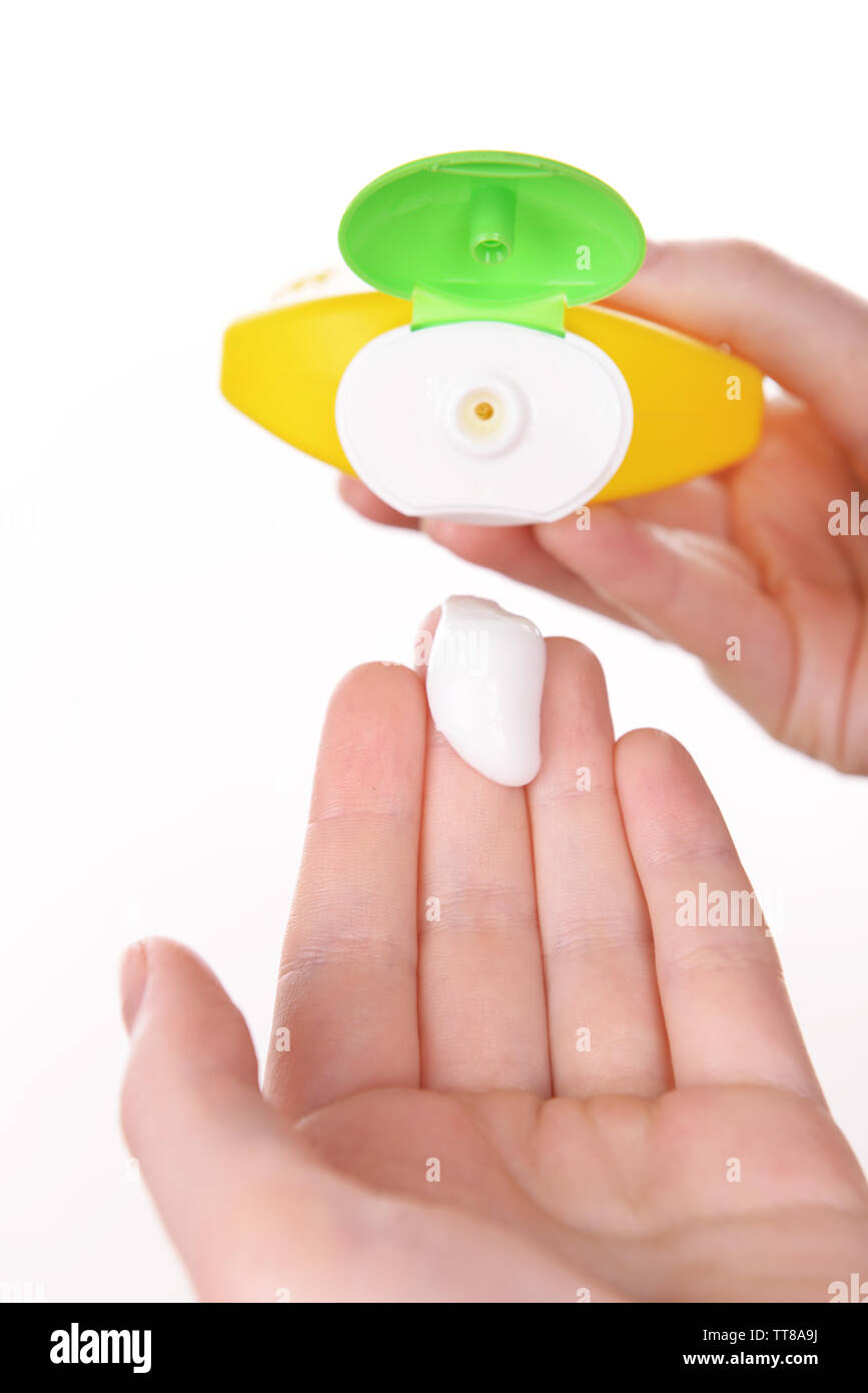 Bottle of suntan cream in female hands isolated on white Stock Photo ...