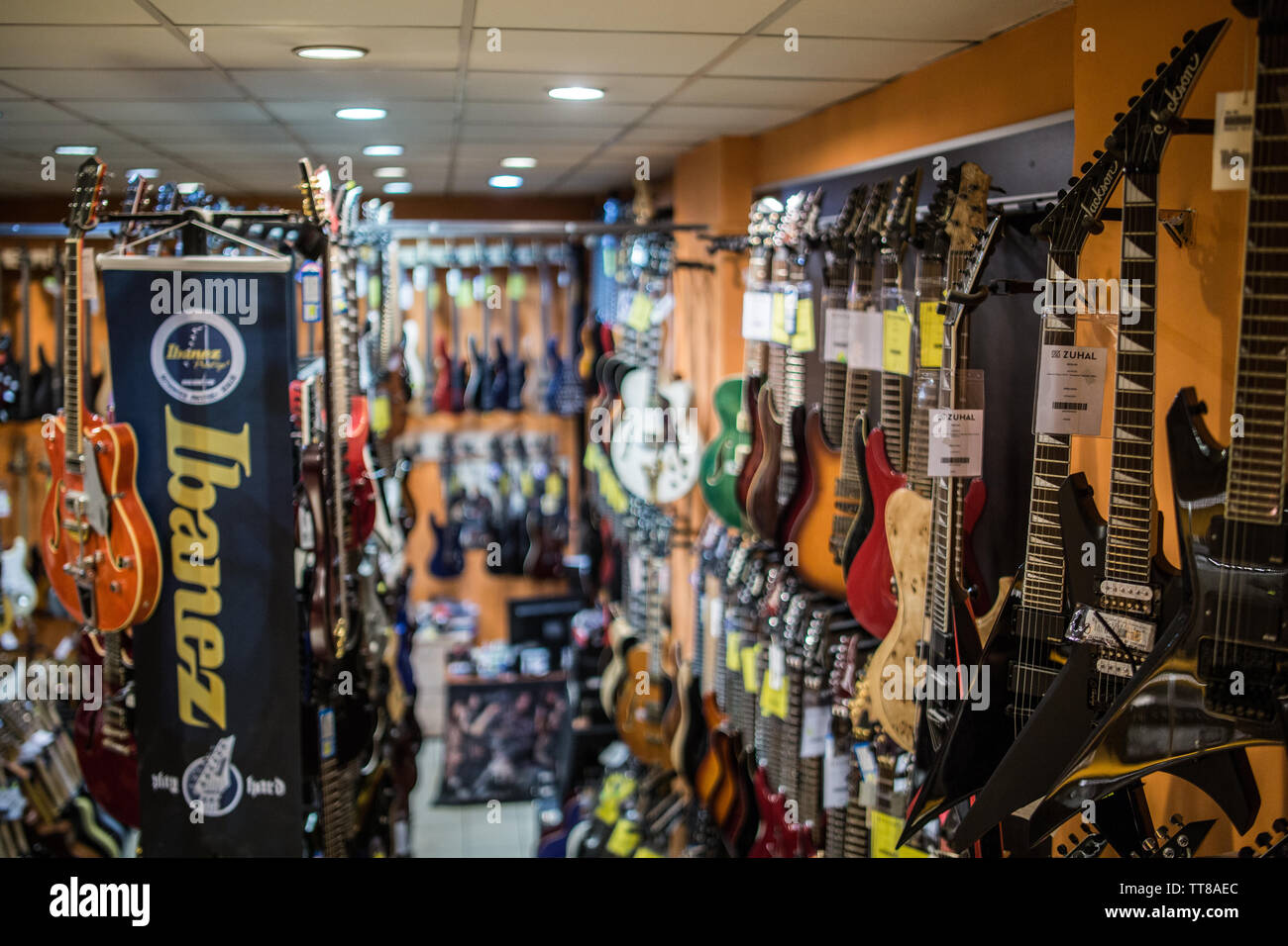lots of electric guitars on sale at music store guitarists heaven Stock ...