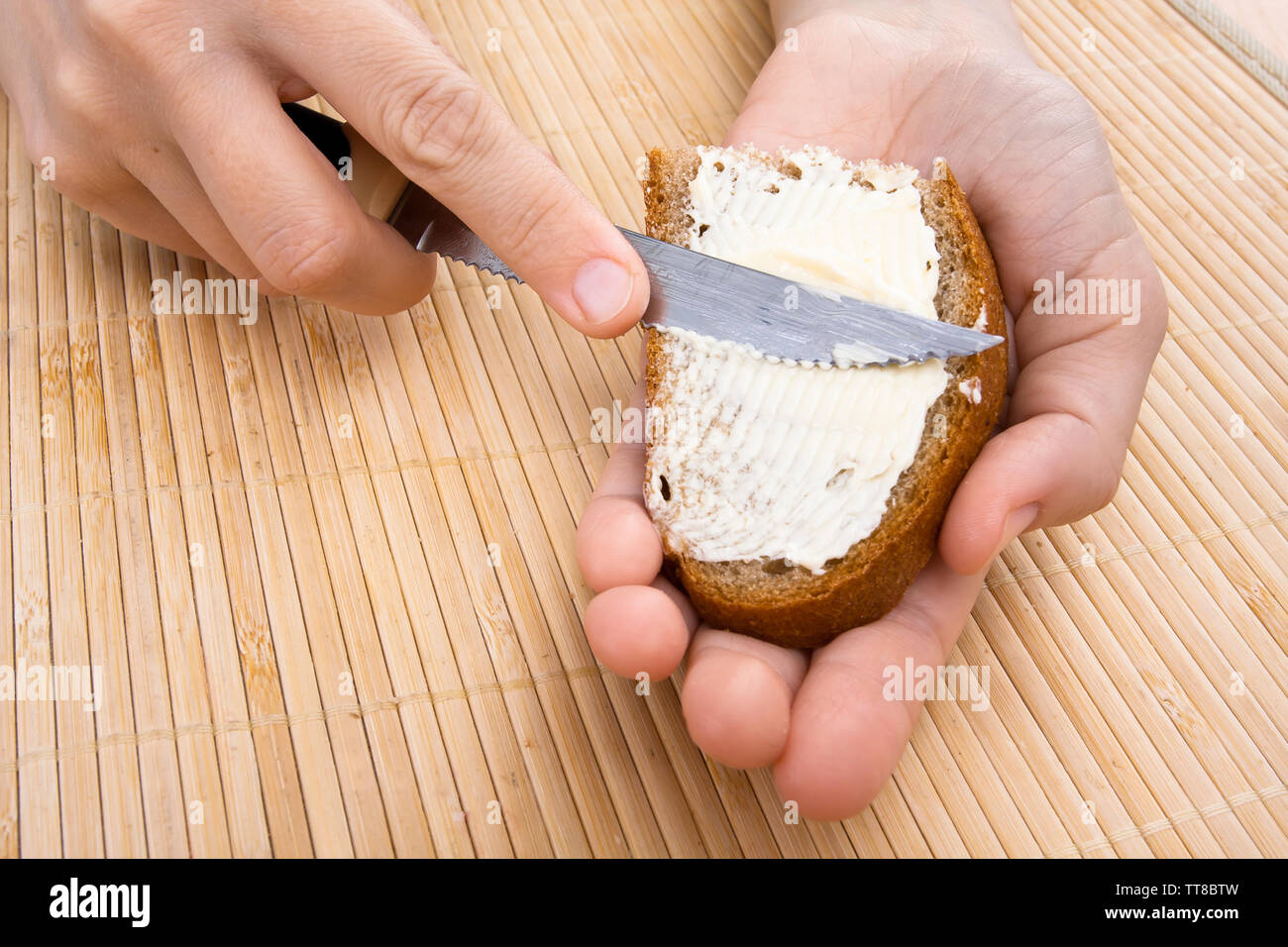 woman hands spreading butter on piece of rye bread, closeup Stock Photo ...