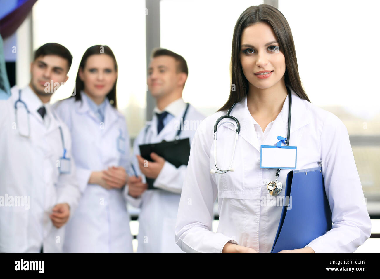 Beautiful young doctor with team in conference room Stock Photo - Alamy
