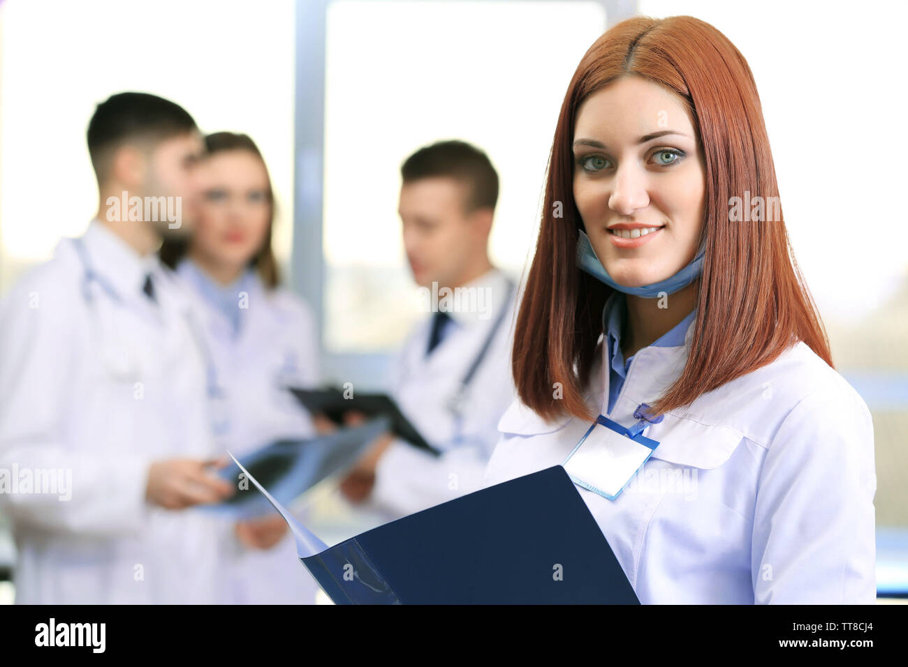 Beautiful young doctor with team in conference room Stock Photo - Alamy