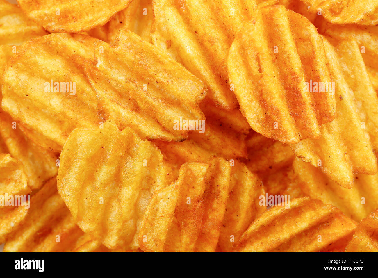 Delicious potato chips closeup background Stock Photo - Alamy