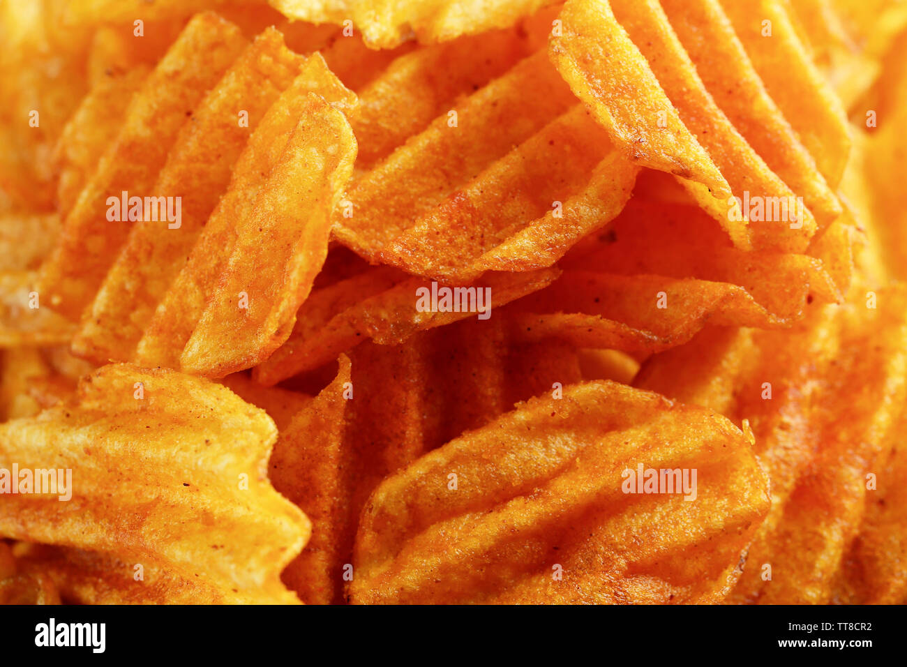Delicious potato chips closeup background Stock Photo - Alamy