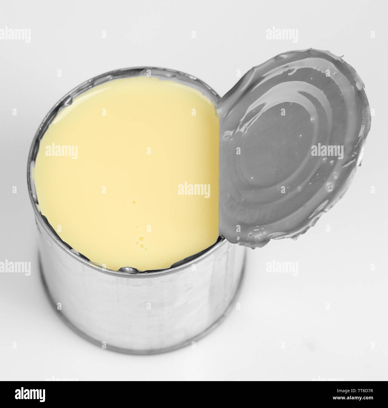 Tin can of condensed milk isolated on white Stock Photo - Alamy