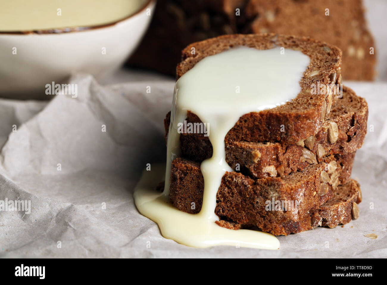 Slices of bread with condensed milk on paper background Stock Photo - Alamy