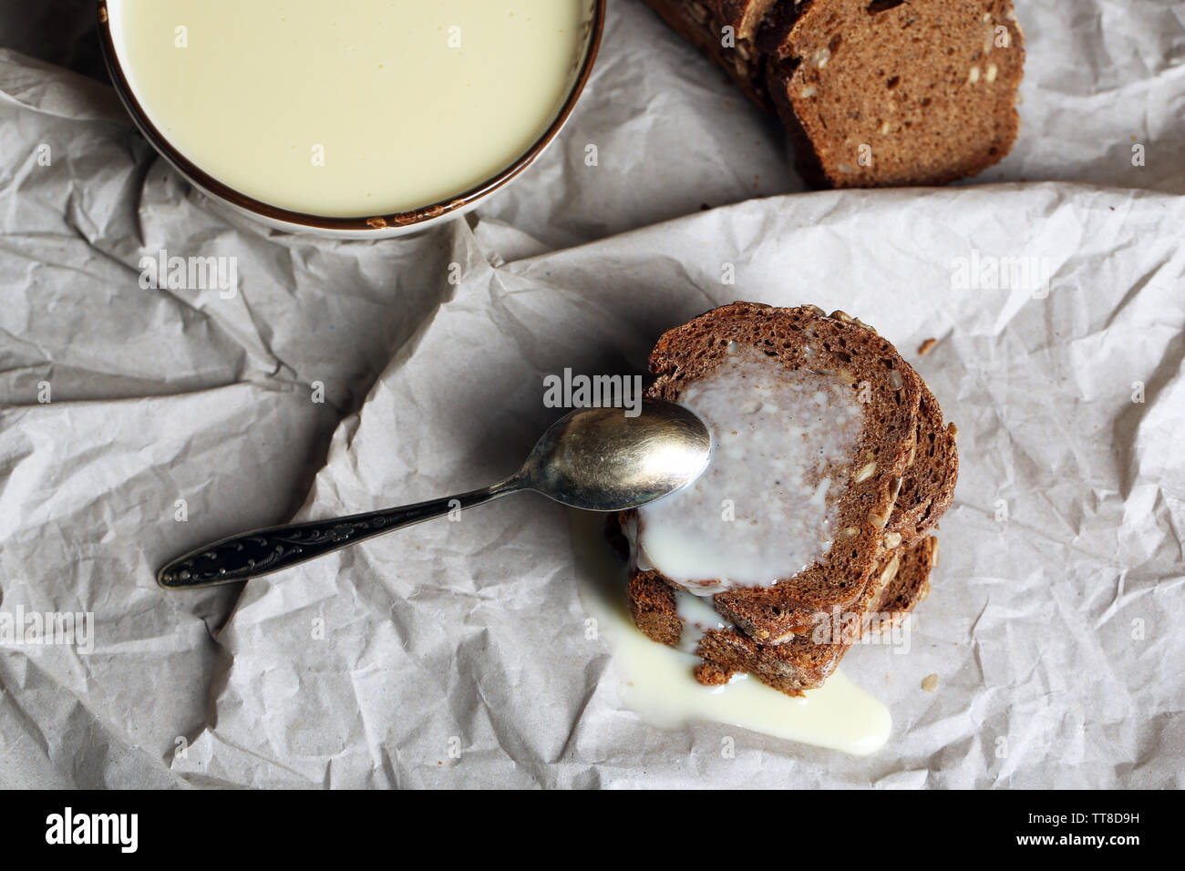 Slices of bread with condensed milk on paper background Stock Photo - Alamy