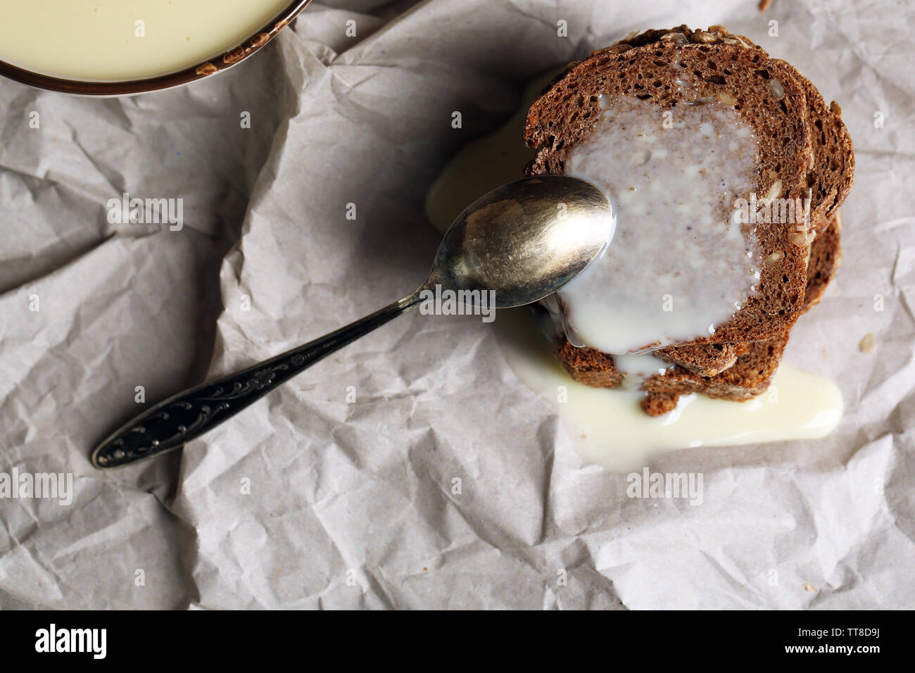 Slices of bread with condensed milk on paper background Stock Photo - Alamy