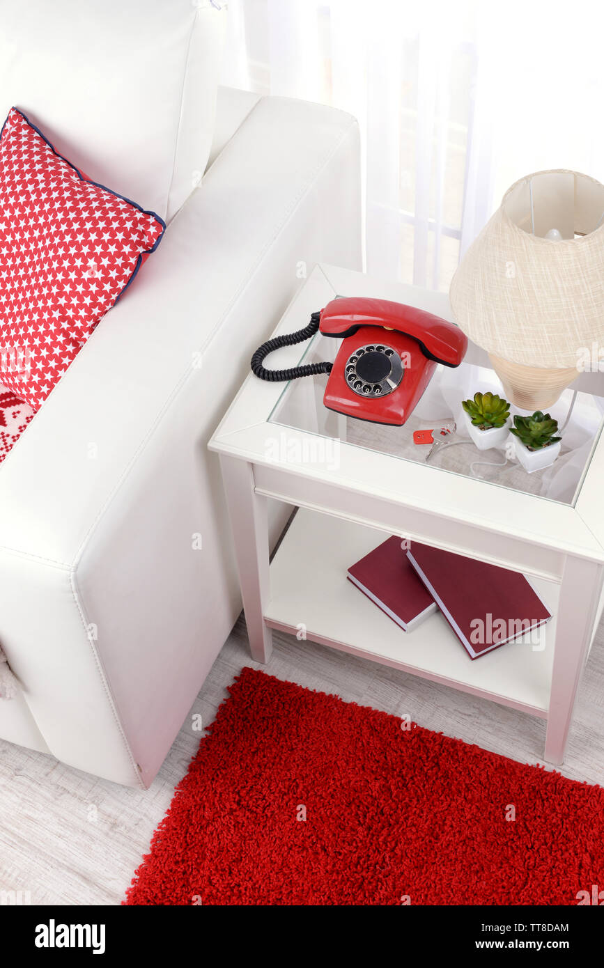 Retro phone on nightstand in room Stock Photo - Alamy