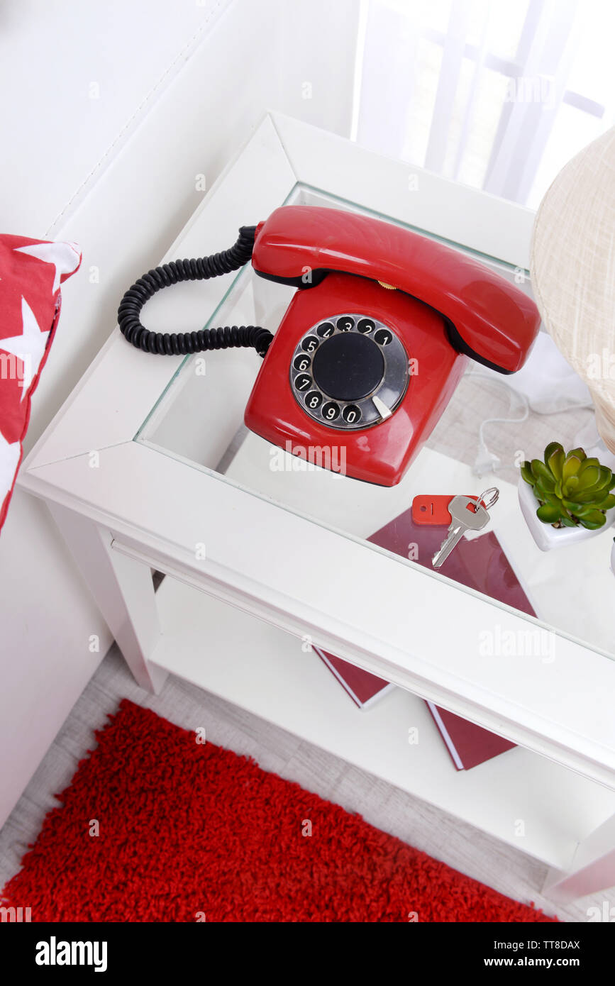 Retro phone on nightstand in room Stock Photo - Alamy