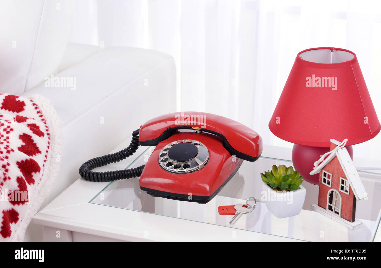 Retro phone on nightstand in room Stock Photo - Alamy