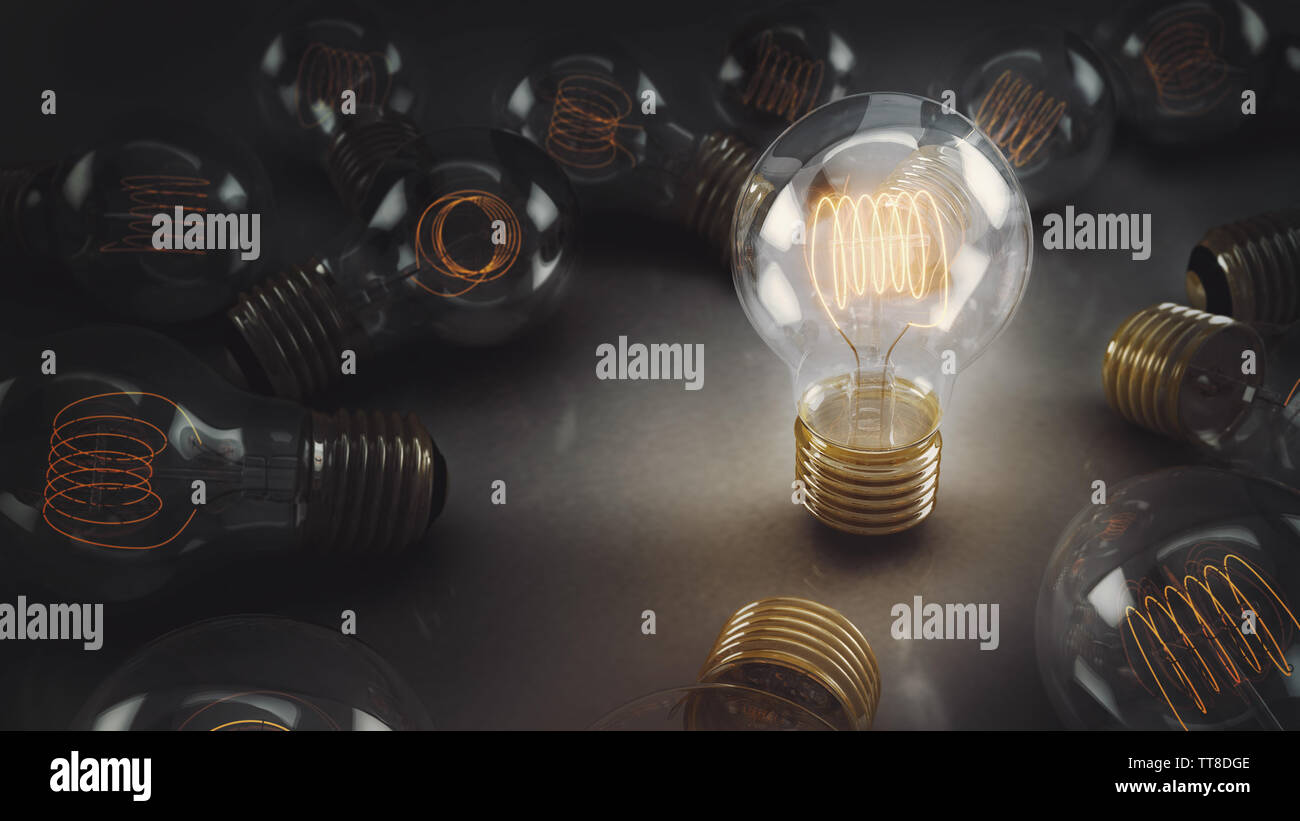 A single incandescent lightbulb surrounded by multiple bulbs on a ...