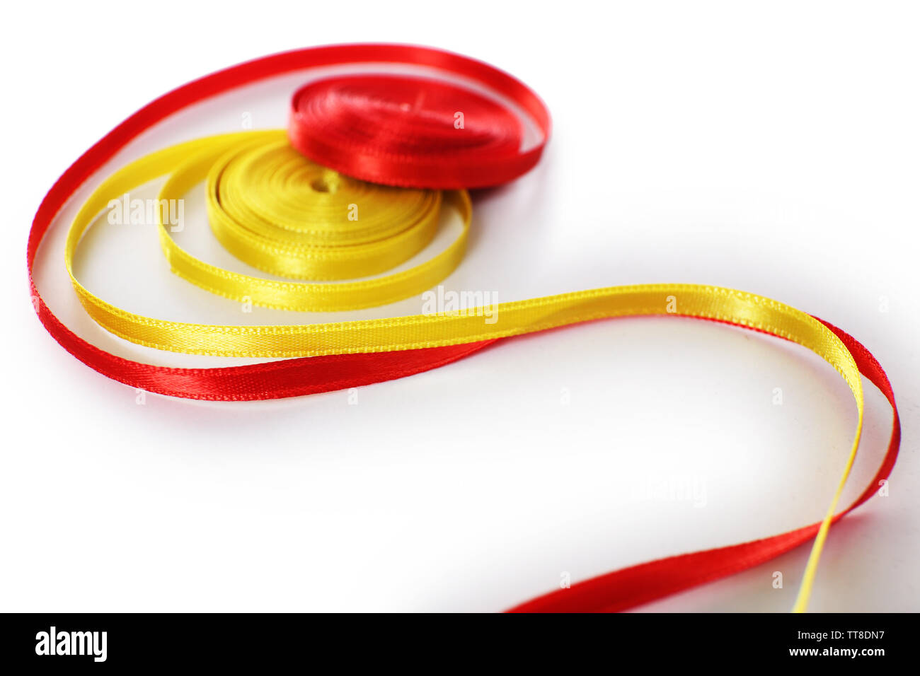 Colorful red and yellow ribbons isolated on white Stock Photo - Alamy