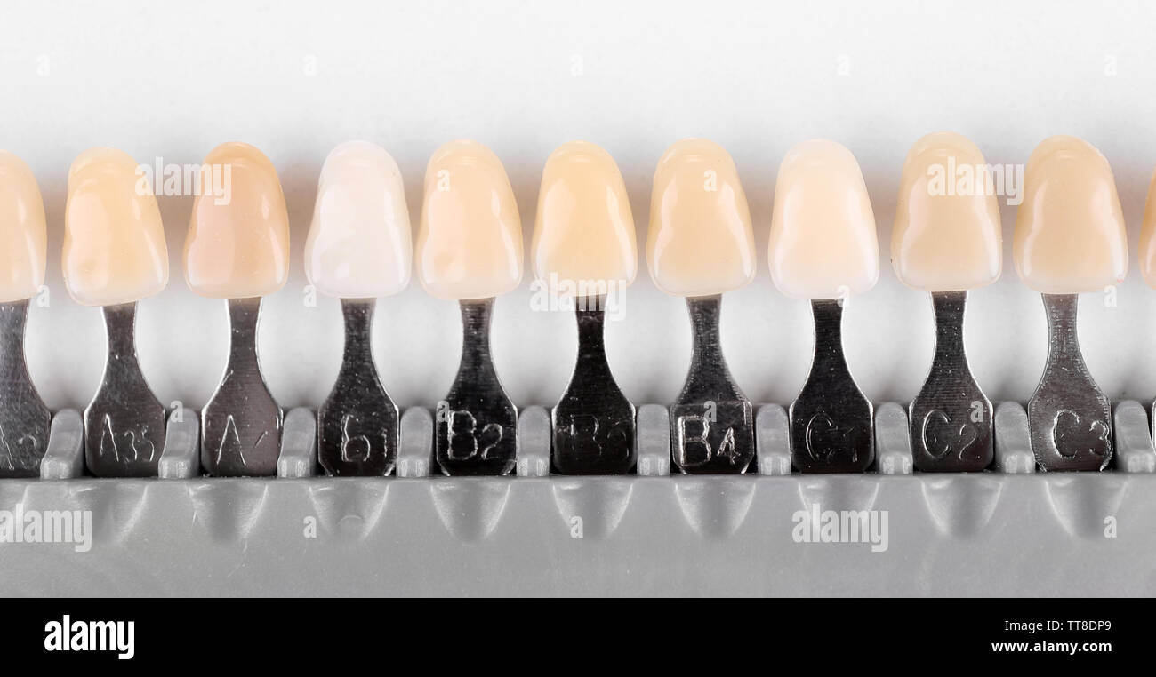 Plastic dental implant for choose color tone of teeth isolated on white ...