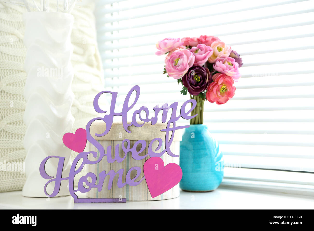Home in colorful letters in light white interior Stock Photo - Alamy