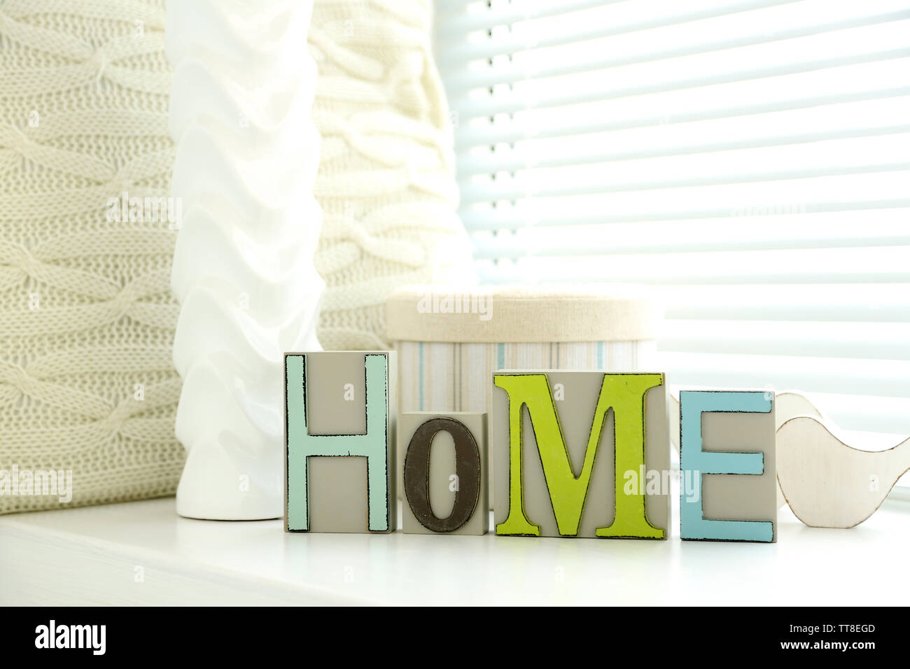 Home in colorful letters in light white interior Stock Photo - Alamy