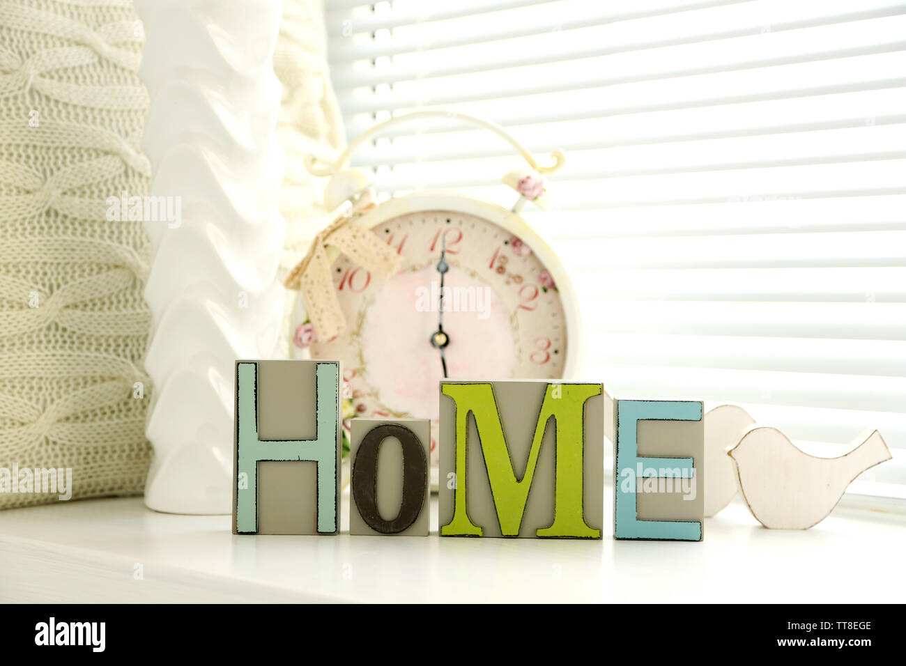 Home in colorful letters in light white interior Stock Photo - Alamy
