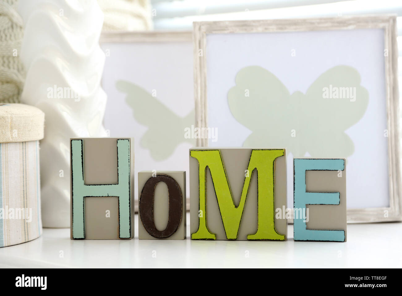 Home in colorful letters in light white interior Stock Photo - Alamy