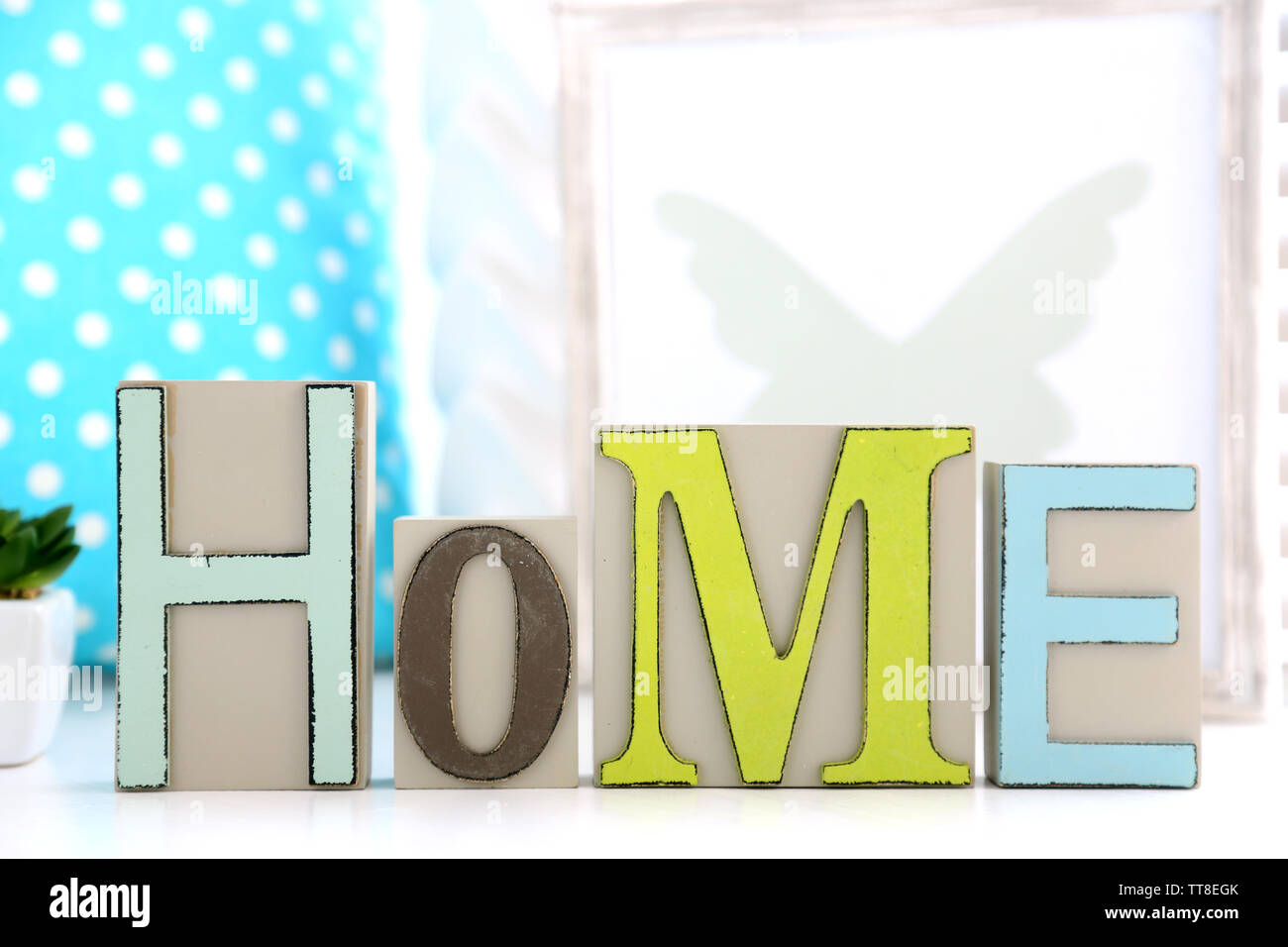 Home in colorful letters in light white interior Stock Photo - Alamy