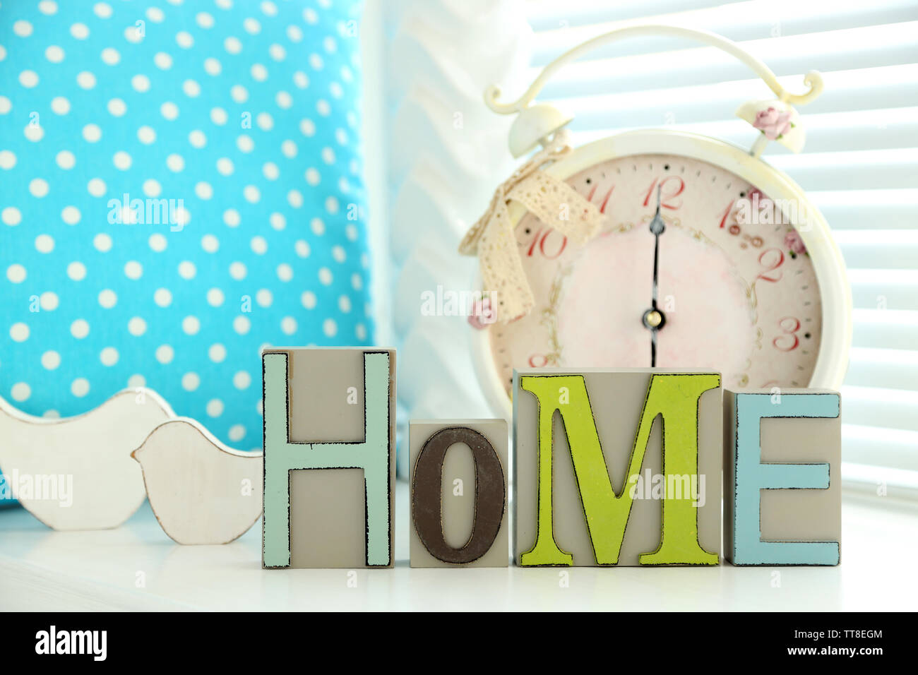 Home in colorful letters in light white interior Stock Photo - Alamy