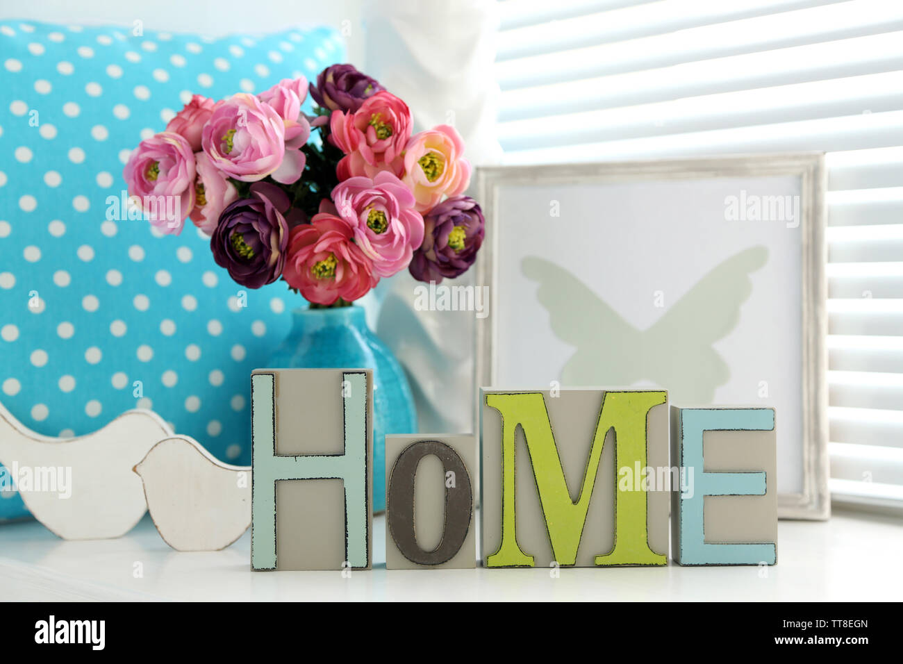 Home in colorful letters in light white interior Stock Photo - Alamy