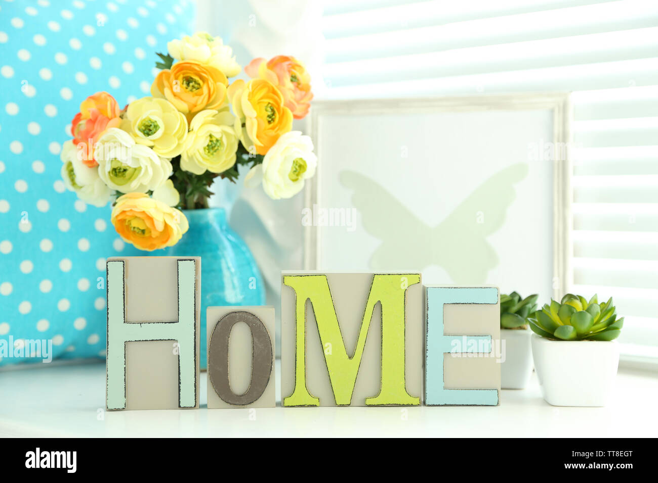 Home in colorful letters in light white interior Stock Photo - Alamy