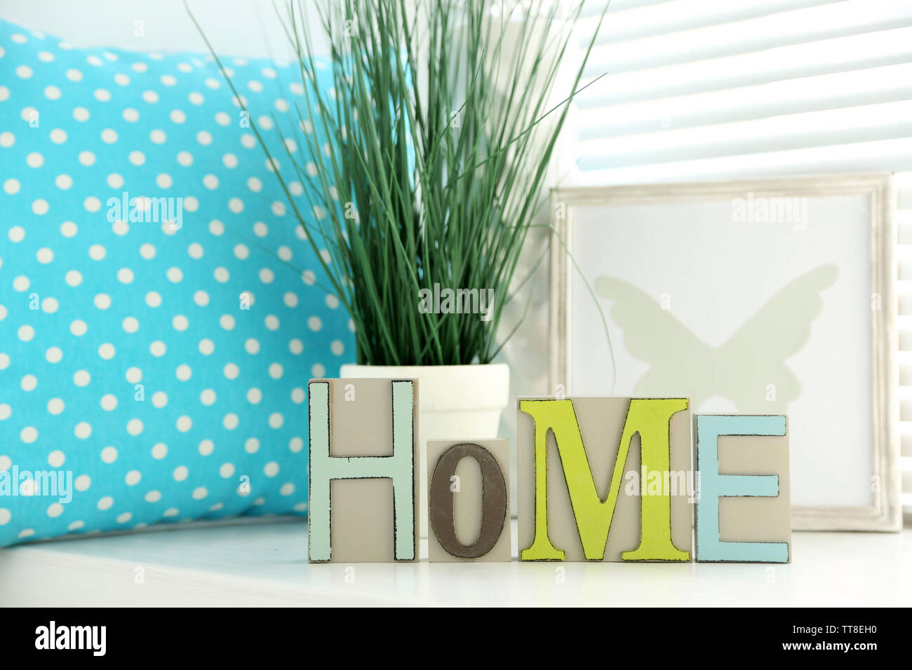 Home in colorful letters in light white interior Stock Photo - Alamy