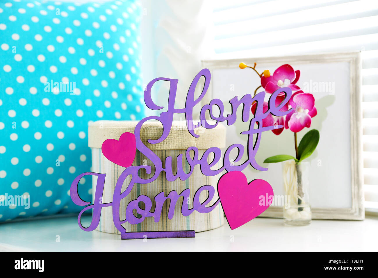 Home in colorful letters in light white interior Stock Photo - Alamy