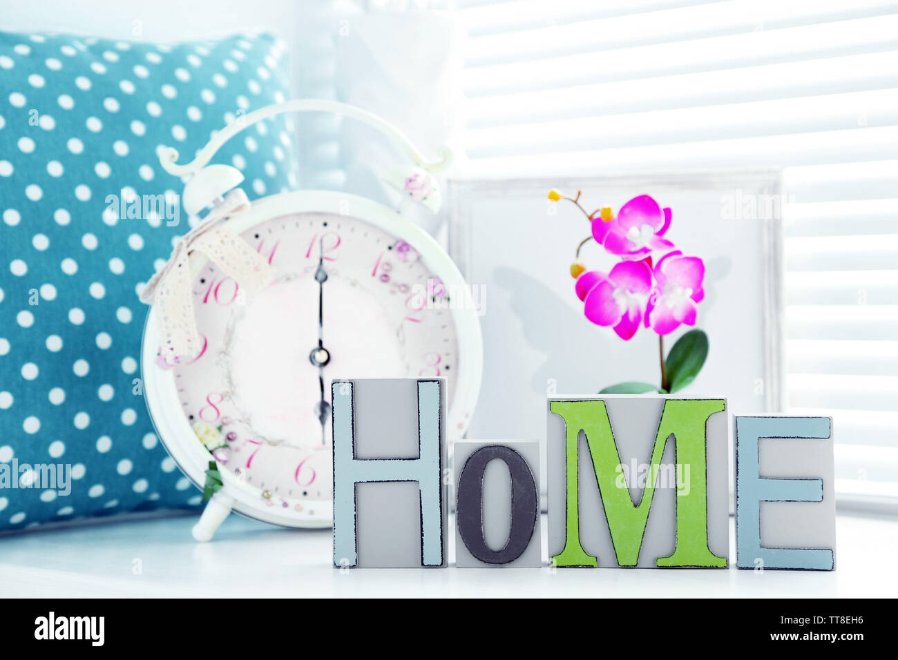 Home in colorful letters in light white interior Stock Photo - Alamy