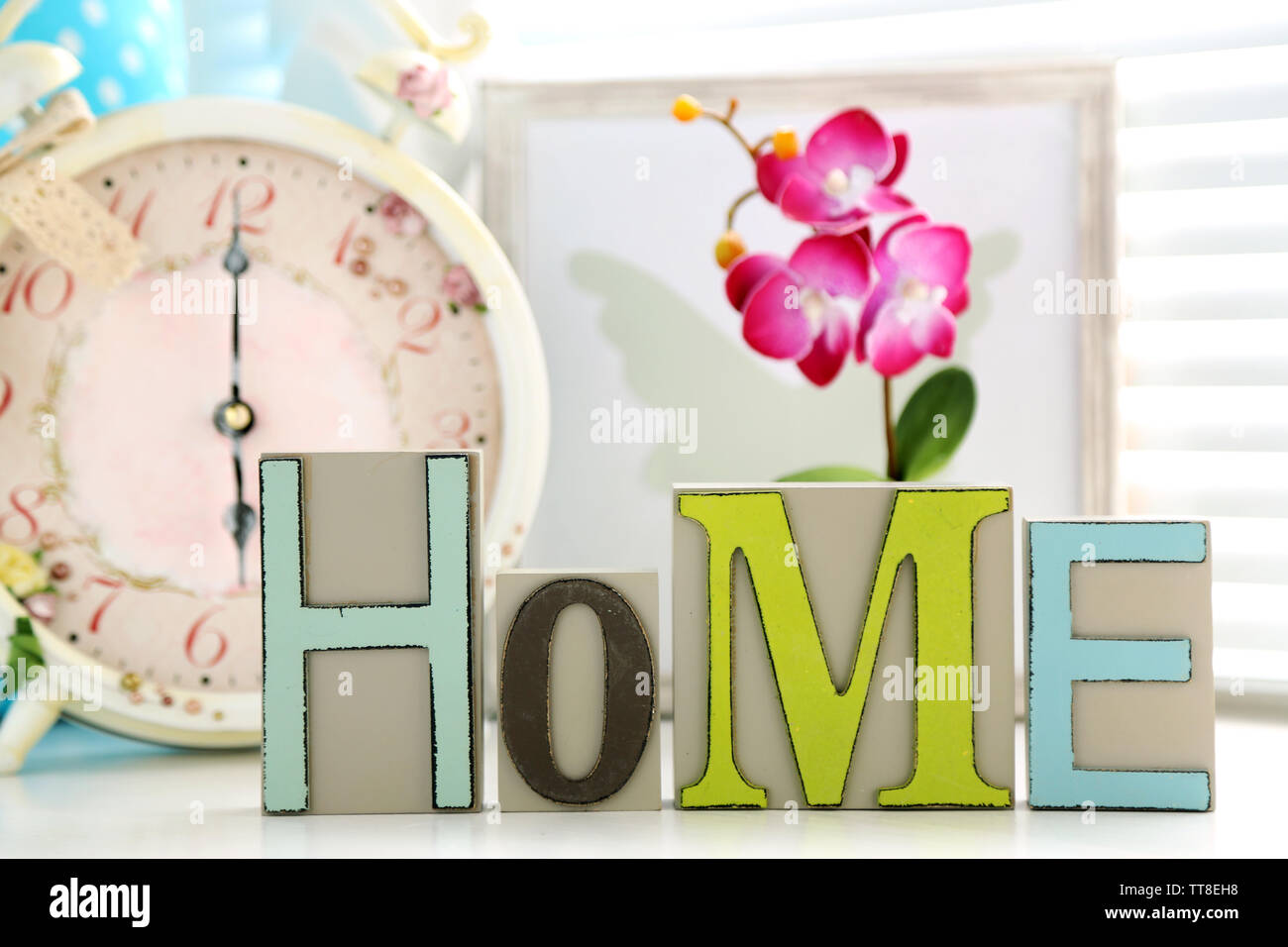 Home in colorful letters in light white interior Stock Photo - Alamy